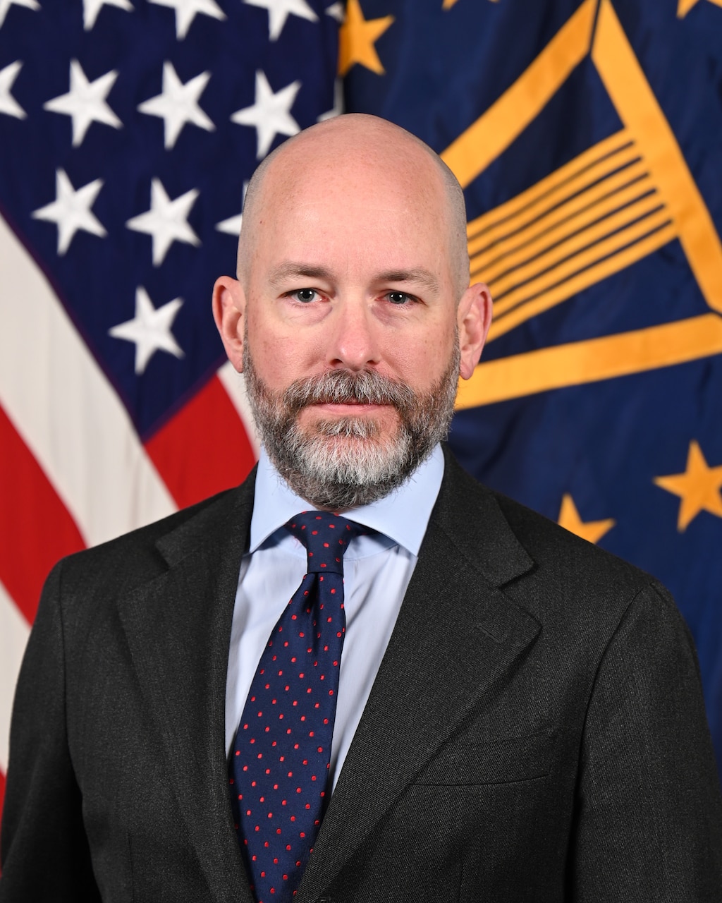 Christopher Mewett > U.S. Department of War > Biography