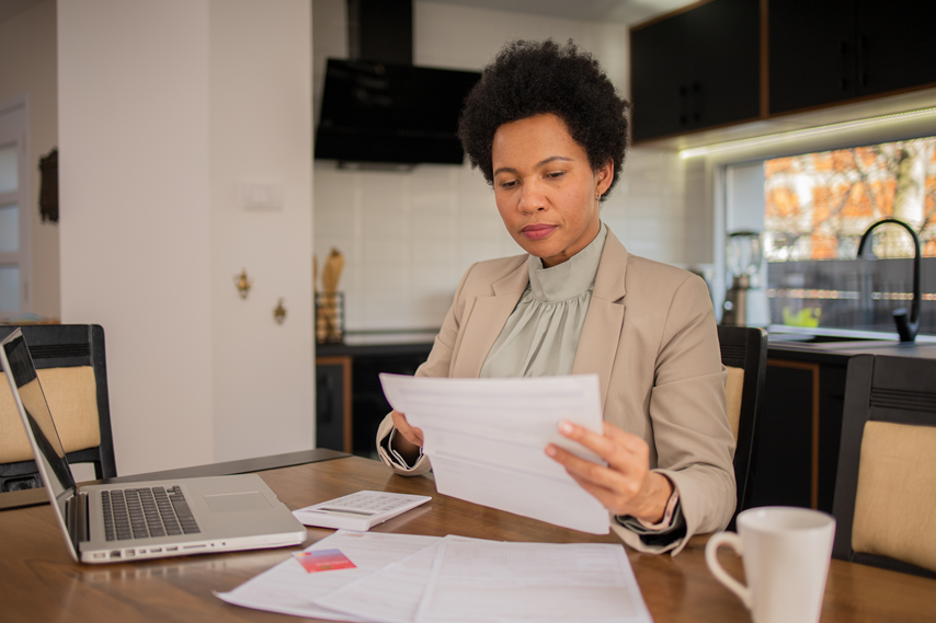 Mature woman going through paperwork stock photo