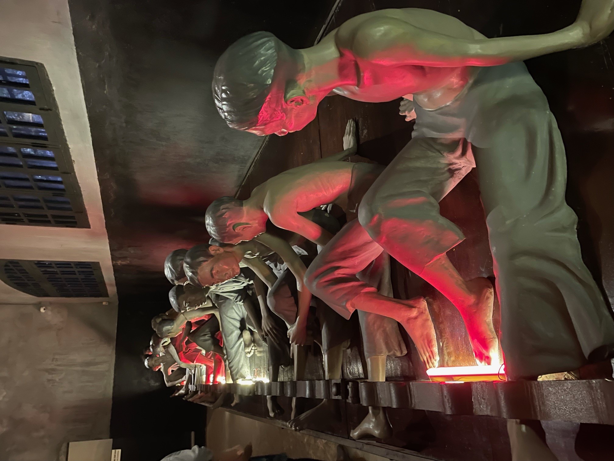 Mannequins at the Hoa Lo Prison Relic displaying leg stocks