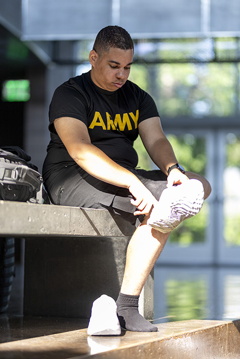 U.S. Army Pfc. Colby Maury-Rice tries on his new shoes at the Team Army ...