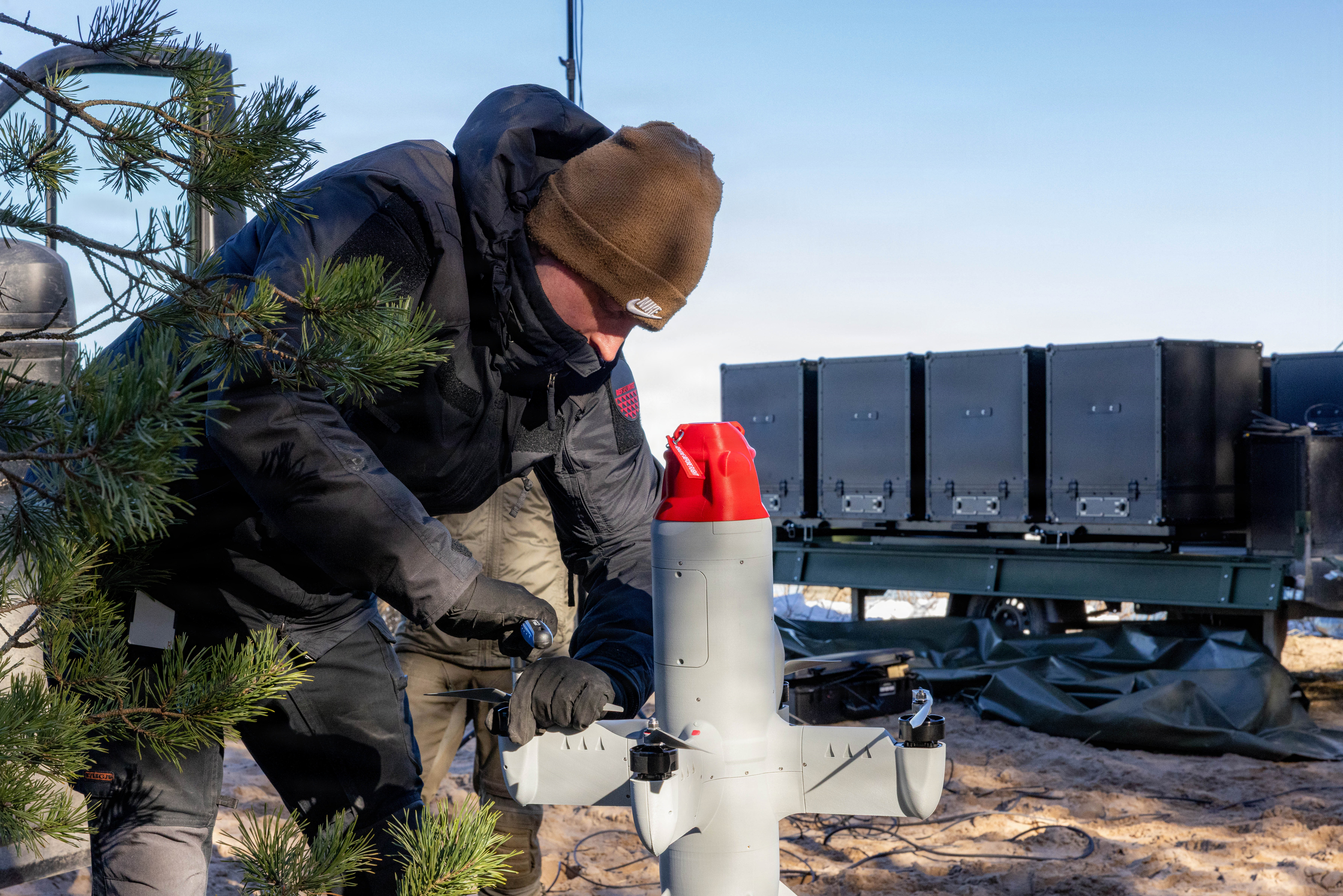 A civilian defense contractor readies a counter-drone defense system ...